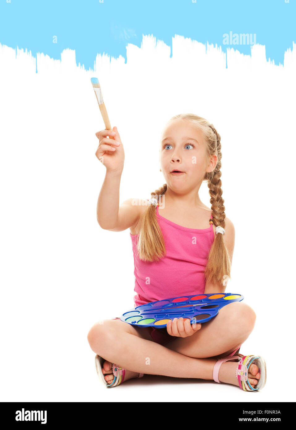 Beautiful little girl painting with blue paint Stock Photo - Alamy