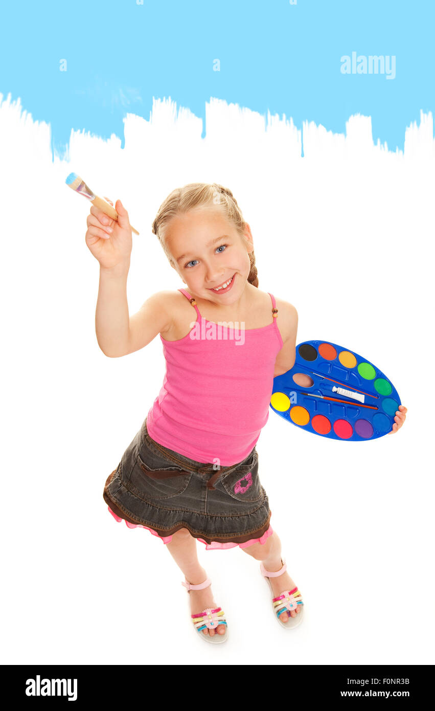 Beautiful little girl painting with blue paint Stock Photo - Alamy