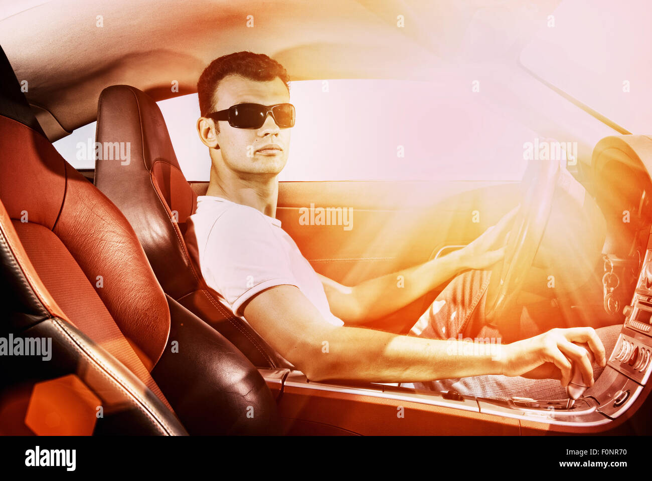 Handsome young man driving modern sport car Stock Photo - Alamy