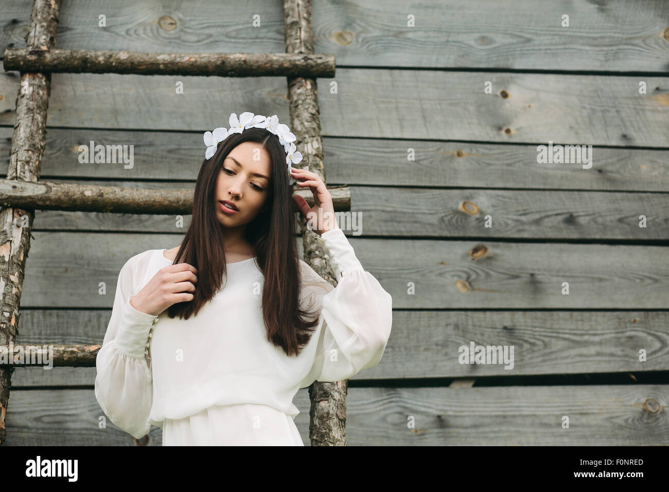 Girl climbing ladder into tree house Stock Photo - Alamy