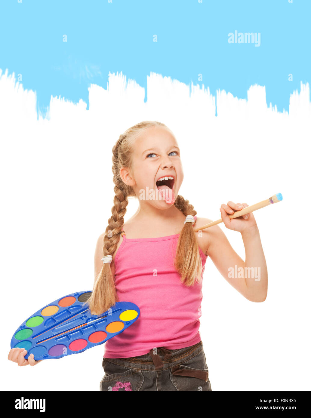 Beautiful little girl painting with blue paint Stock Photo - Alamy