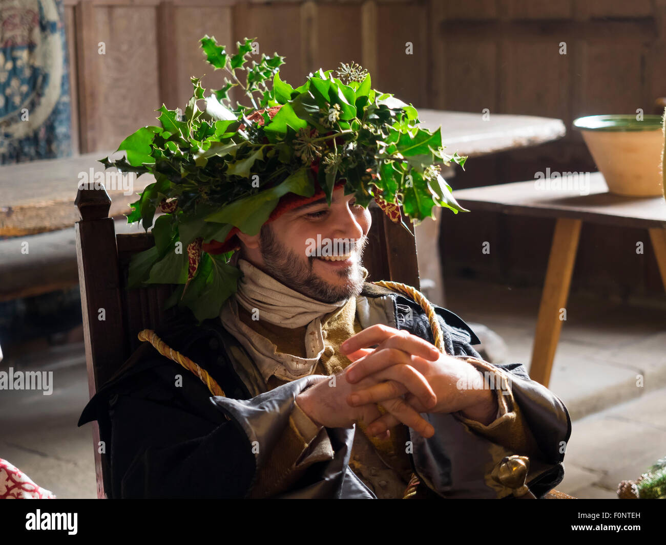 Man wearing holly crown smiling Tudor Christmas in Haddon Hall in ...