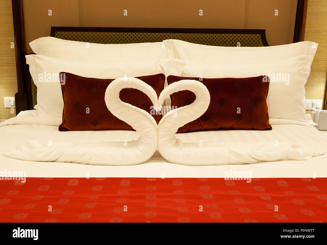Hotel room with towel forming heart shape Stock Photo - Alamy