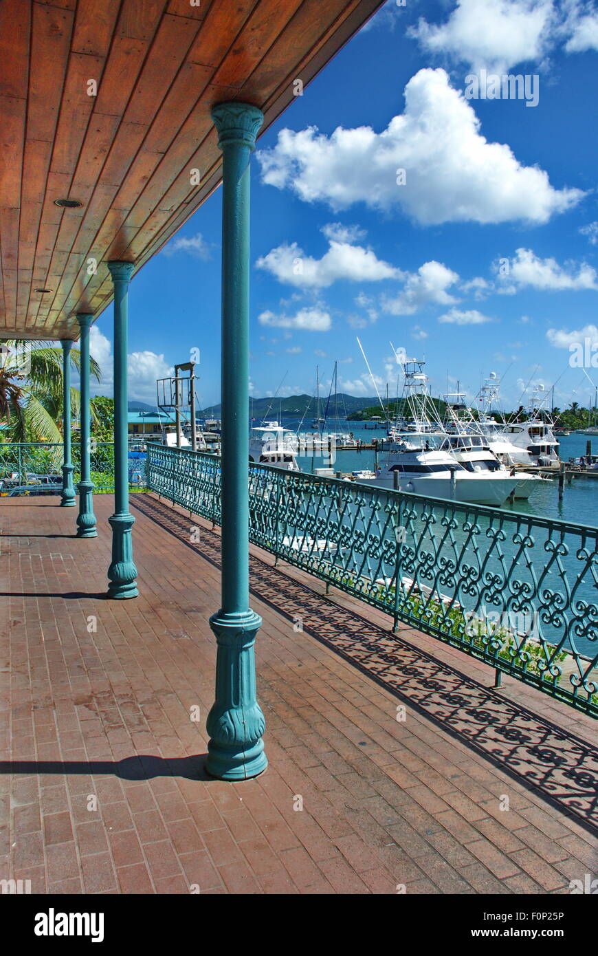 Brick deck walkway with scrolled iron fence overlooking the marina in ...