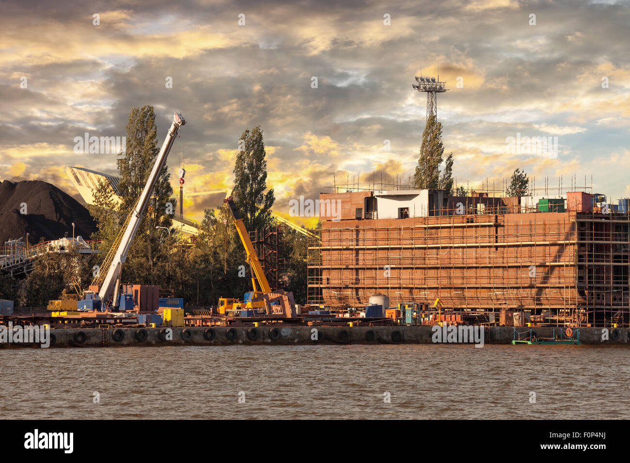 Ship under construction in shipyard at sunrise Stock Photo - Alamy