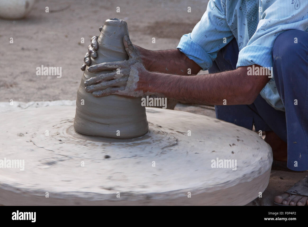 Village potter in Rajasthan, India, creating a new vessel using a ...