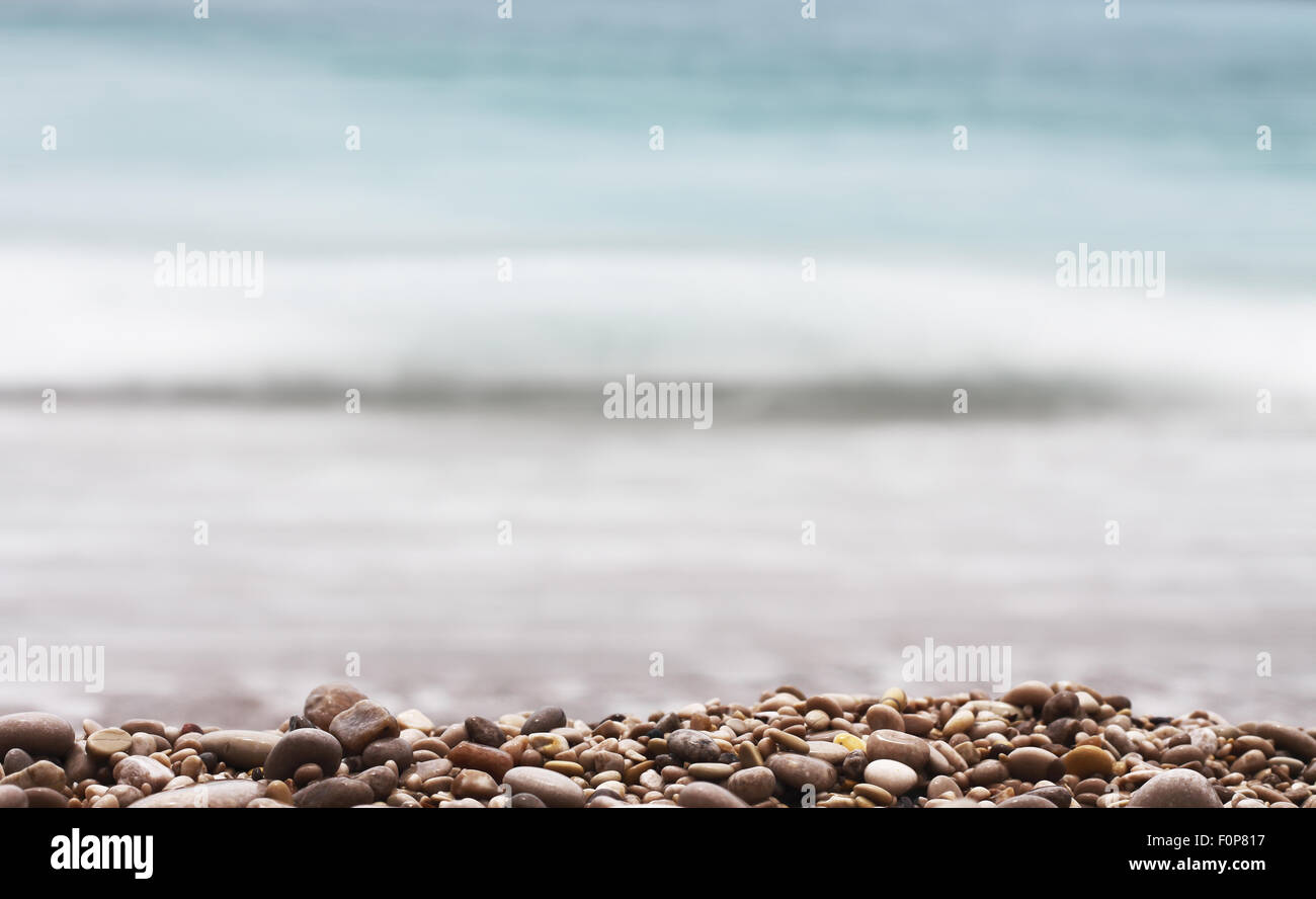gravel depth of field with sea background theme Stock Photo - Alamy