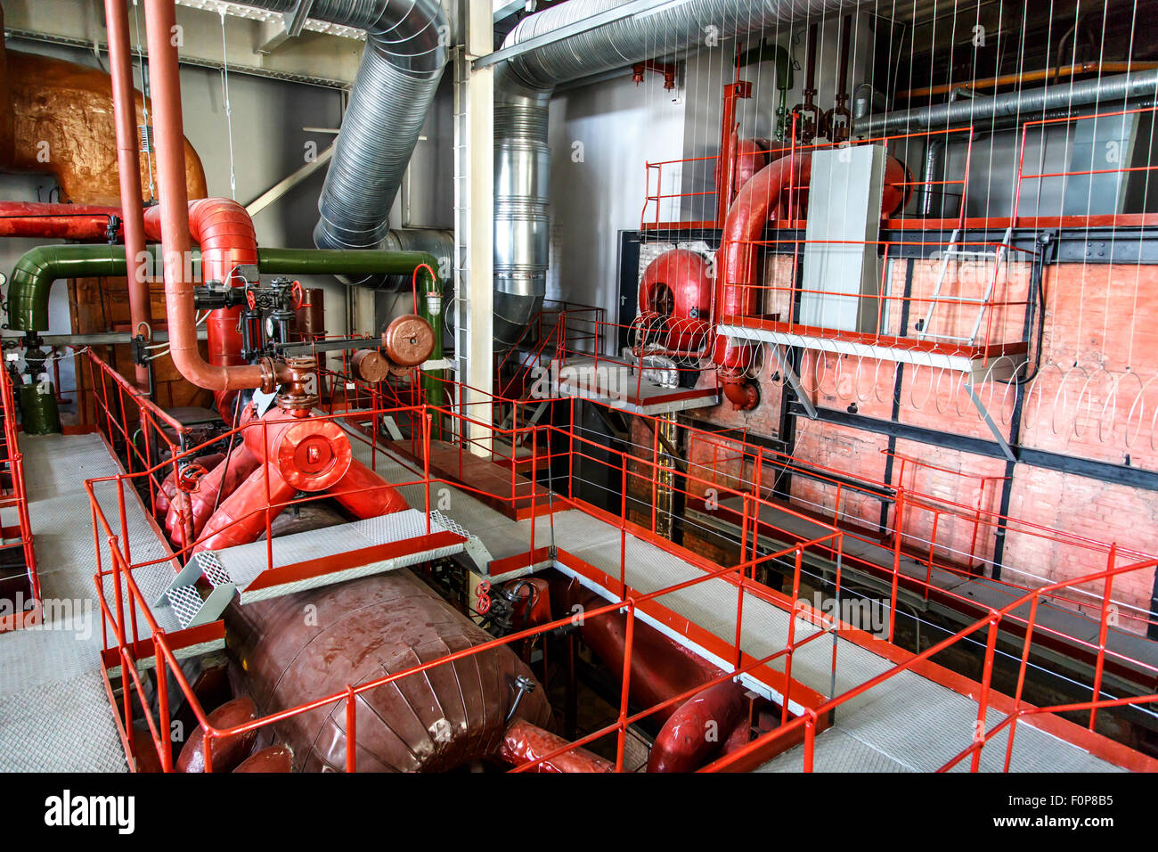 View of red valves and pipes around in a factory or mechanical control ...