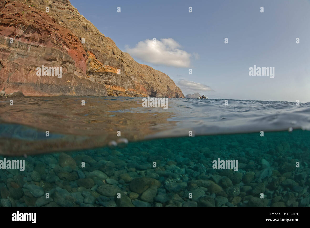 Deserta Grande coastal cliffs and pebbles on seabed, Desertas Islands ...