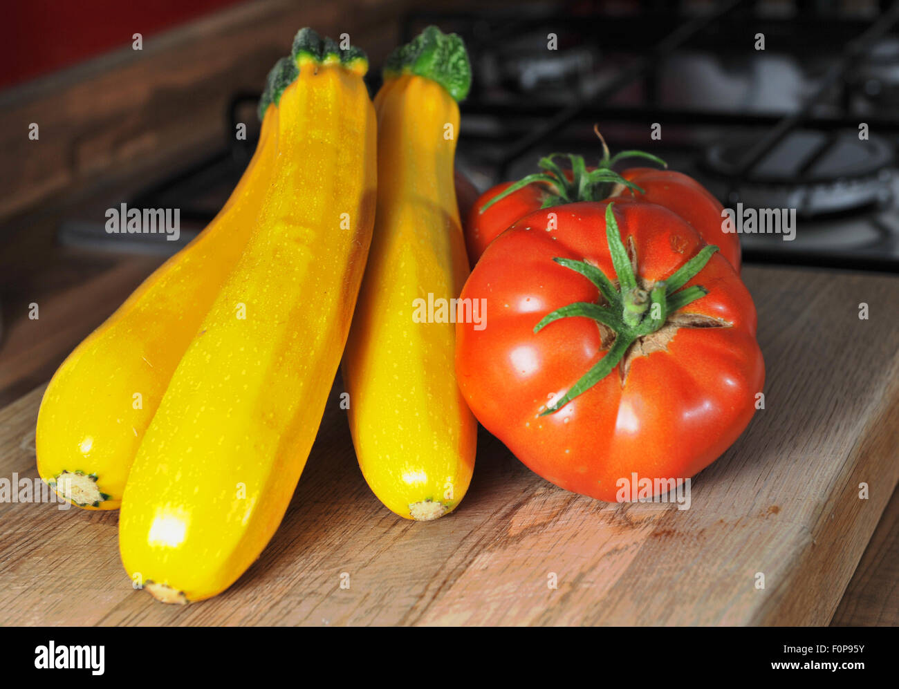 Large red beef tomatoes and yellow courgettes Stock Photo - Alamy