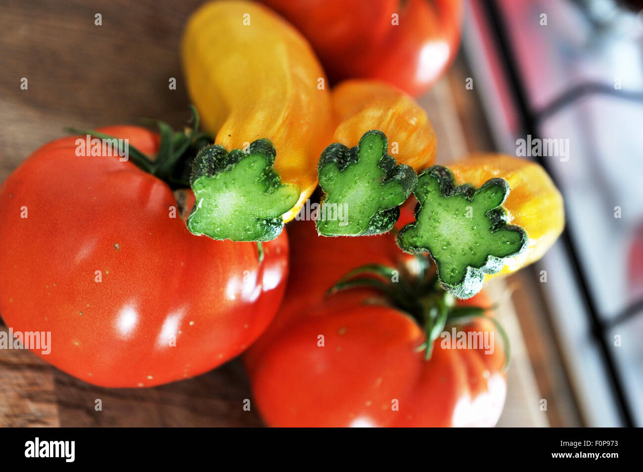Large red beef tomatoes and yellow courgettes Stock Photo - Alamy