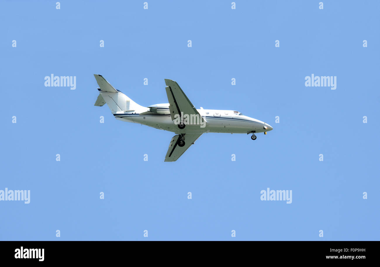 Modern private jet over a bright blue sky getting ready to land Stock ...