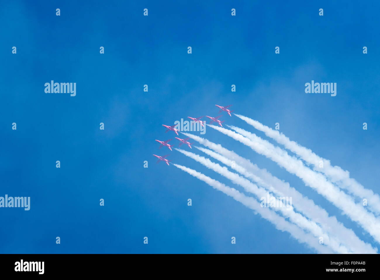 Seven Red Arrows in formation flying upside down and releasing smoke at ...