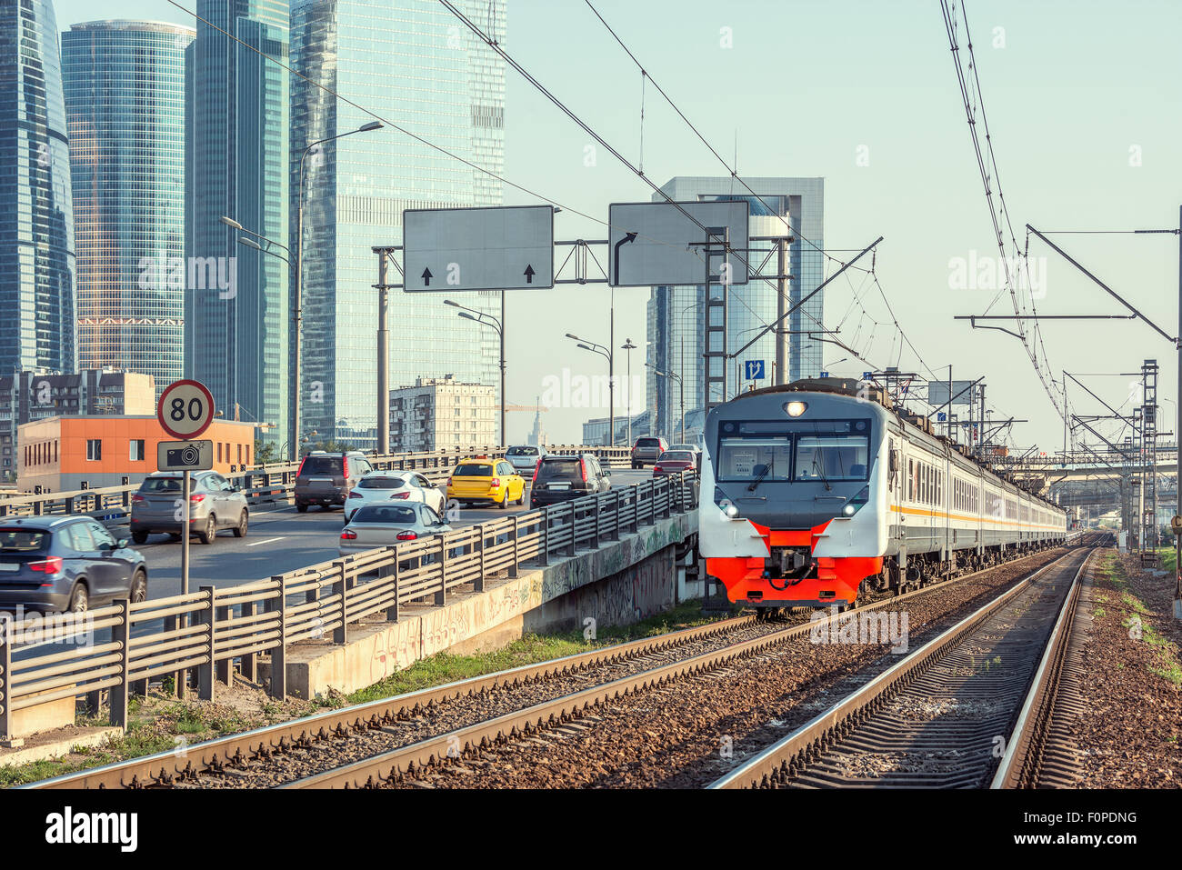 Passenger train by the highway near the business city center Stock ...
