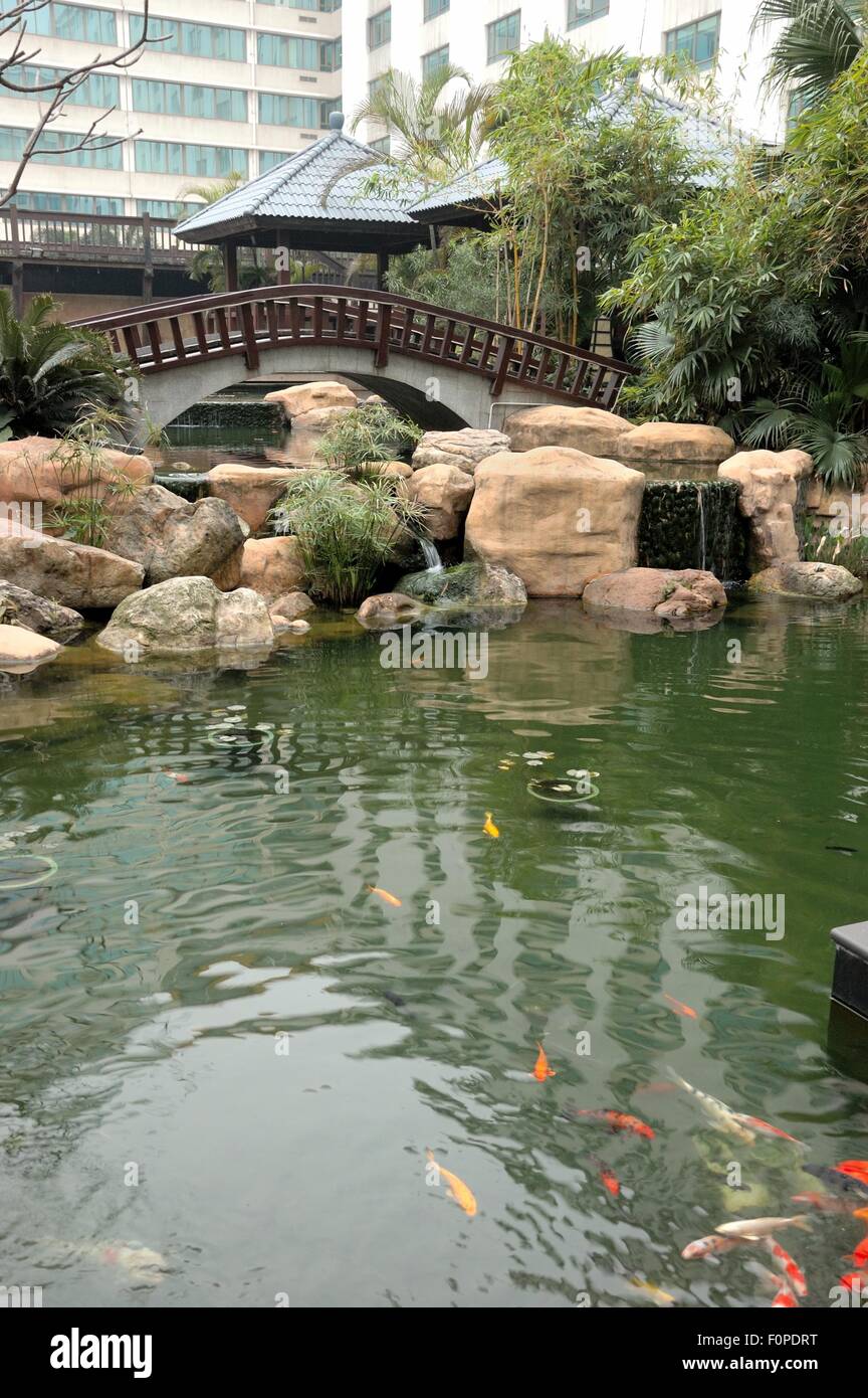 Traditional Chinese garden in Guangzhou with pagoda, pond, rocks and ...