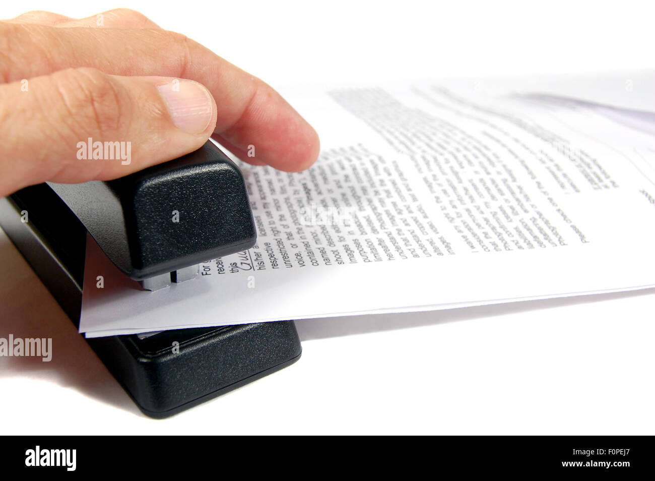 Hand pushing down an stapler isolated on white Stock Photo - Alamy