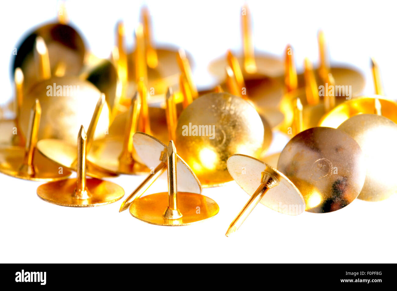 Several golden pin tacks isolated on white Stock Photo - Alamy