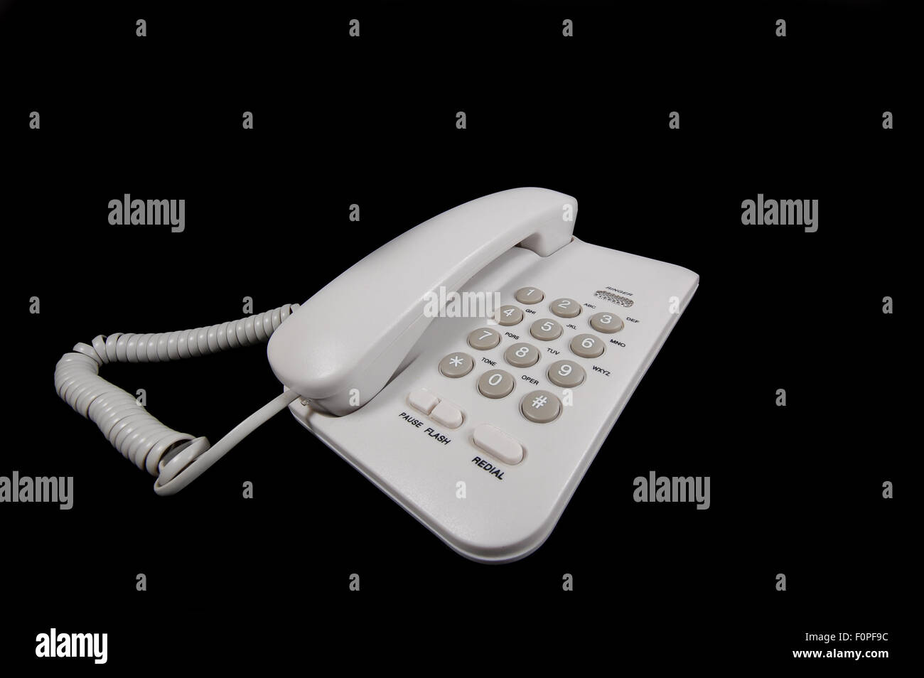 White telephone isolated on a black background Stock Photo - Alamy