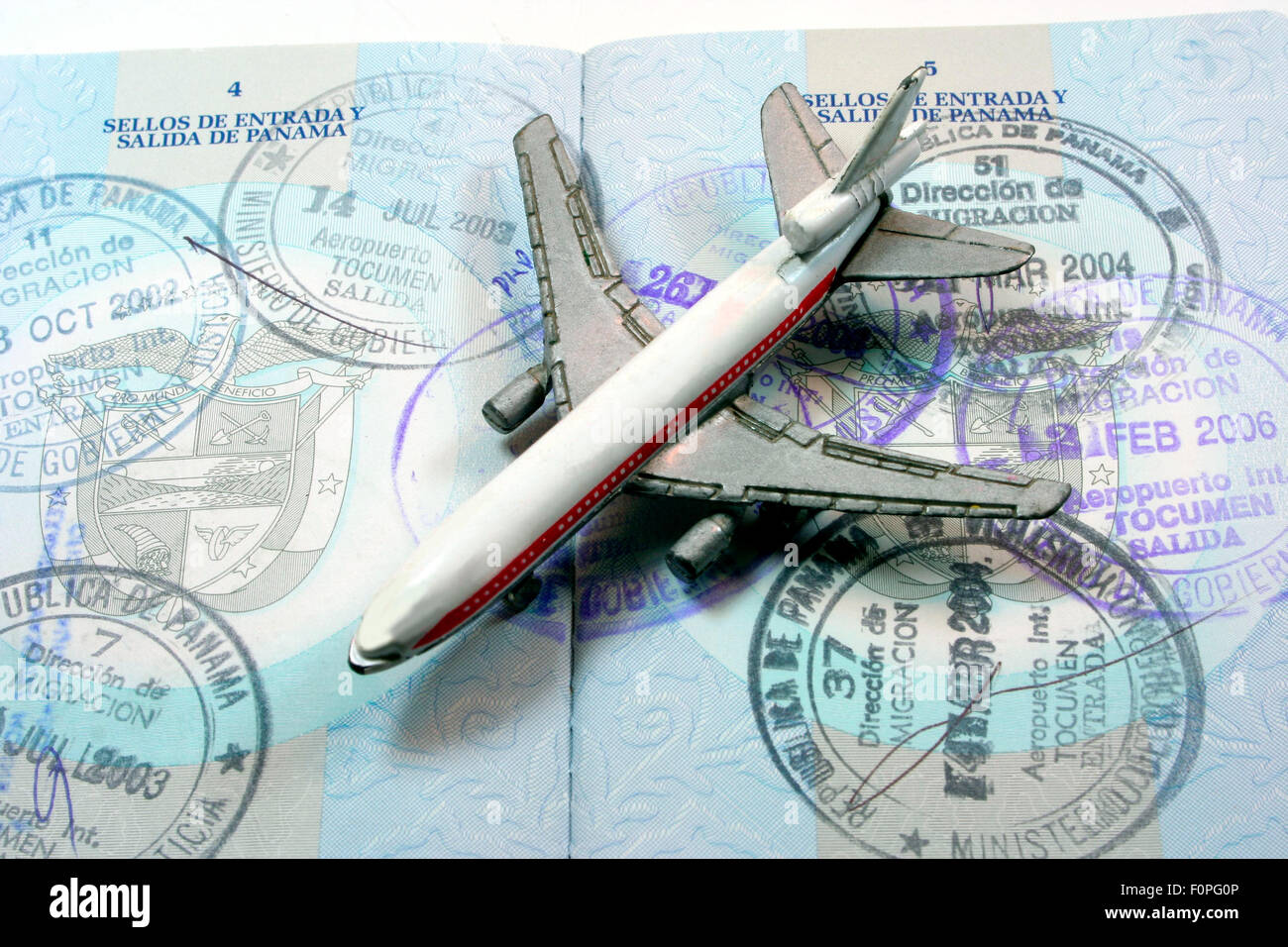 Small toy plane on a passport depicting travel Stock Photo - Alamy