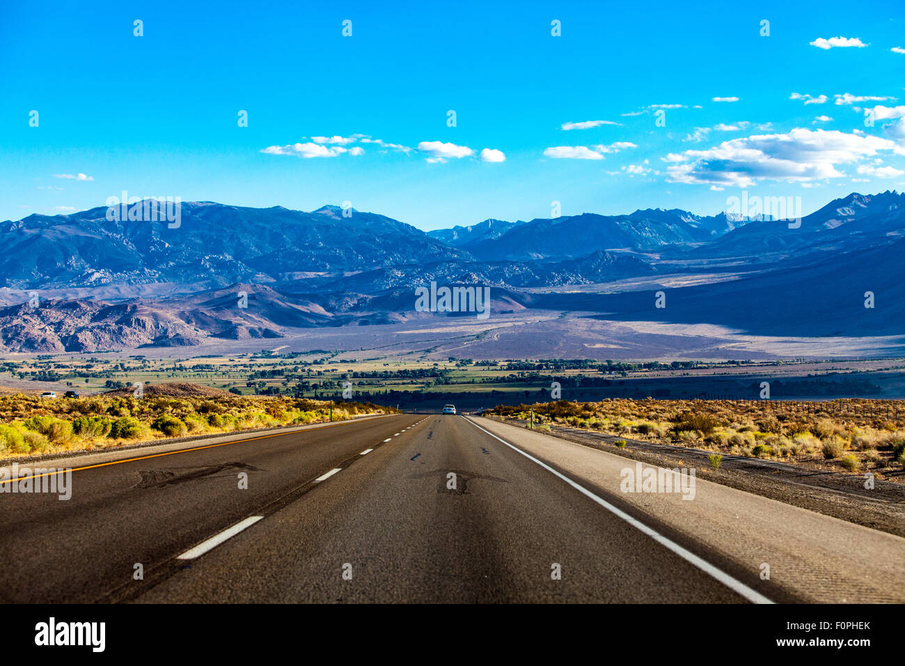 Driving on Calfornia's highway 395 with Round Valley visible ahead ...