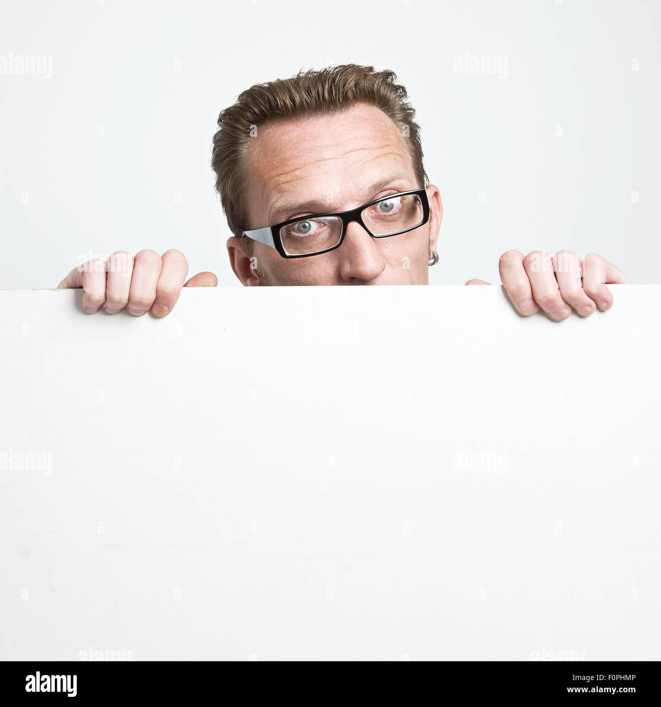 man in eyeglasses peep from the white board. Close up Stock Photo - Alamy