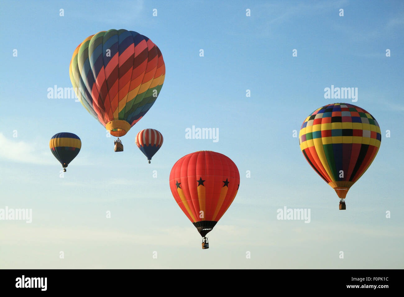 Five colorful balloons floating in blue sky Stock Photo - Alamy