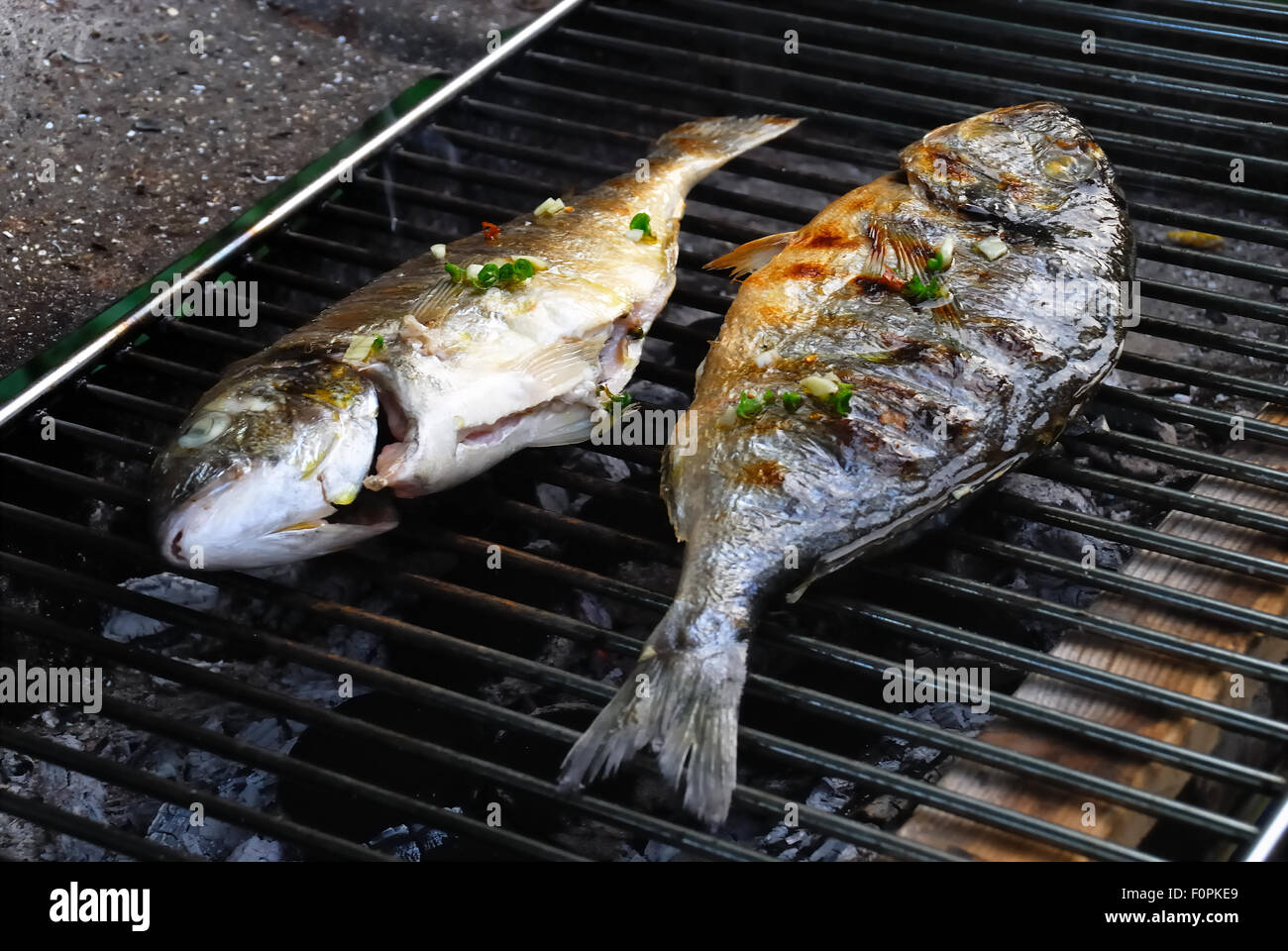 Sea bream cooked on the grill Stock Photo - Alamy