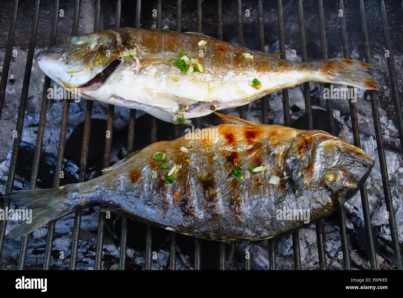 Sea bream cooked on the grill Stock Photo - Alamy