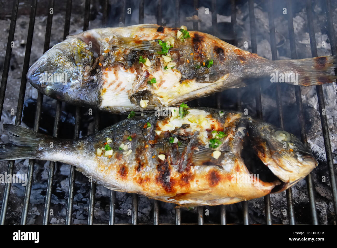 Sea bream cooked on the grill Stock Photo - Alamy