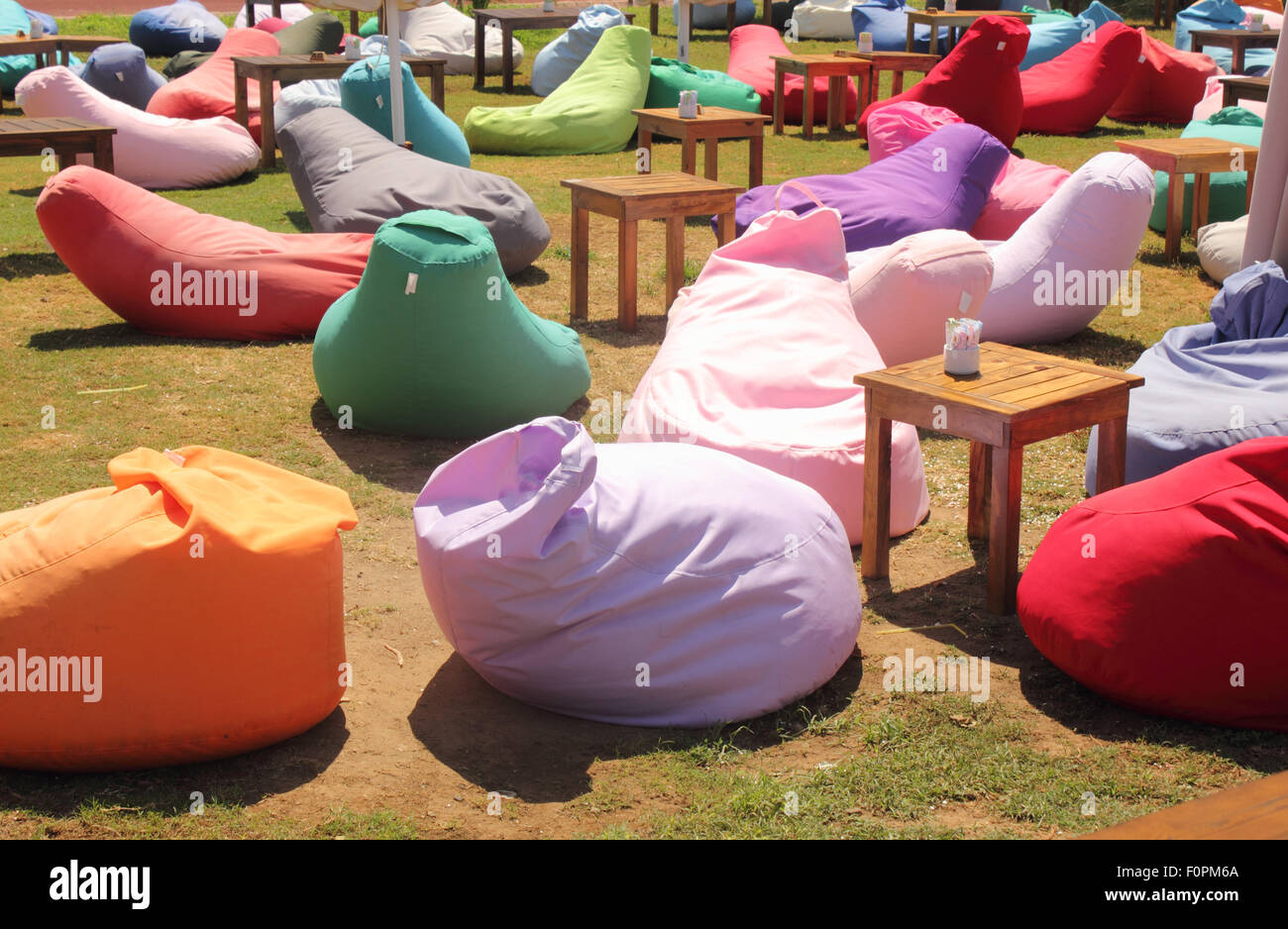 Colourful Beanbags being used for seating on a lawn Stock Photo - Alamy