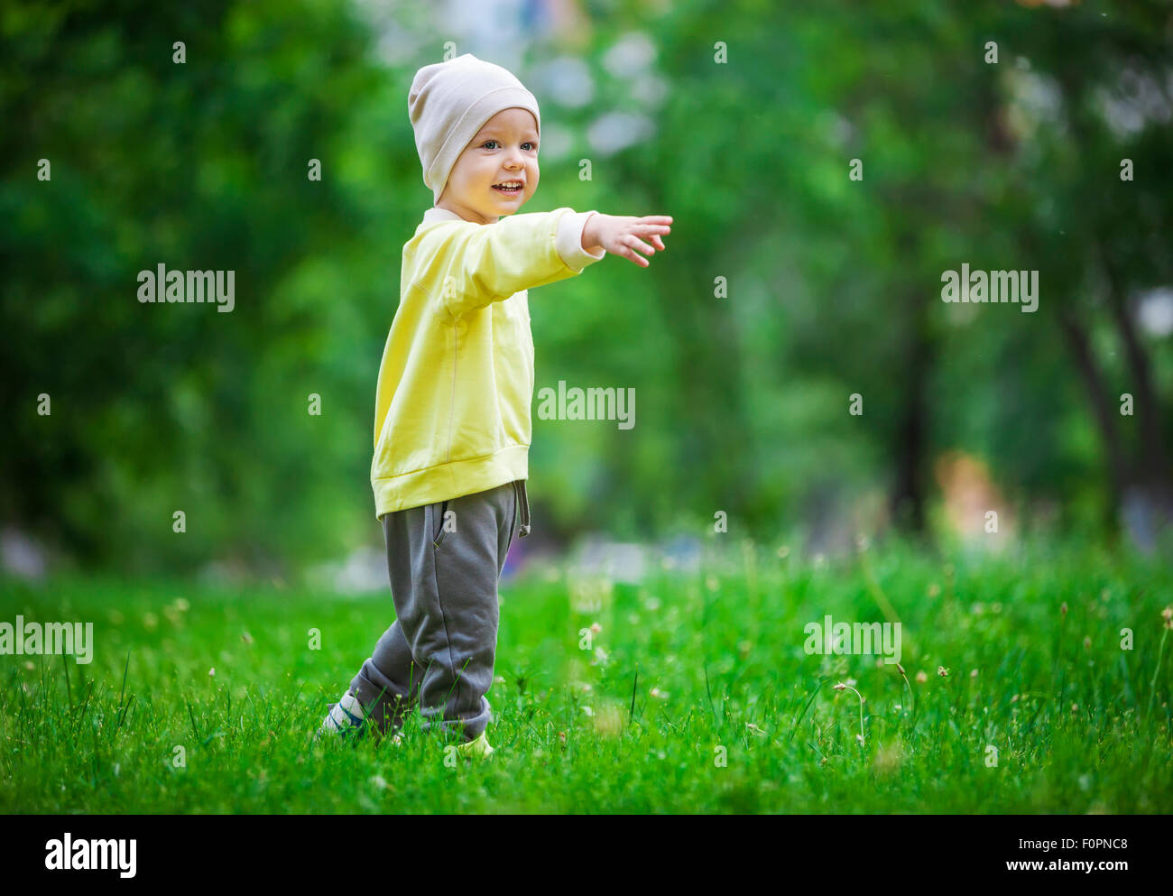 Portrait of a happy little boy pointing at something outdoors Stock ...