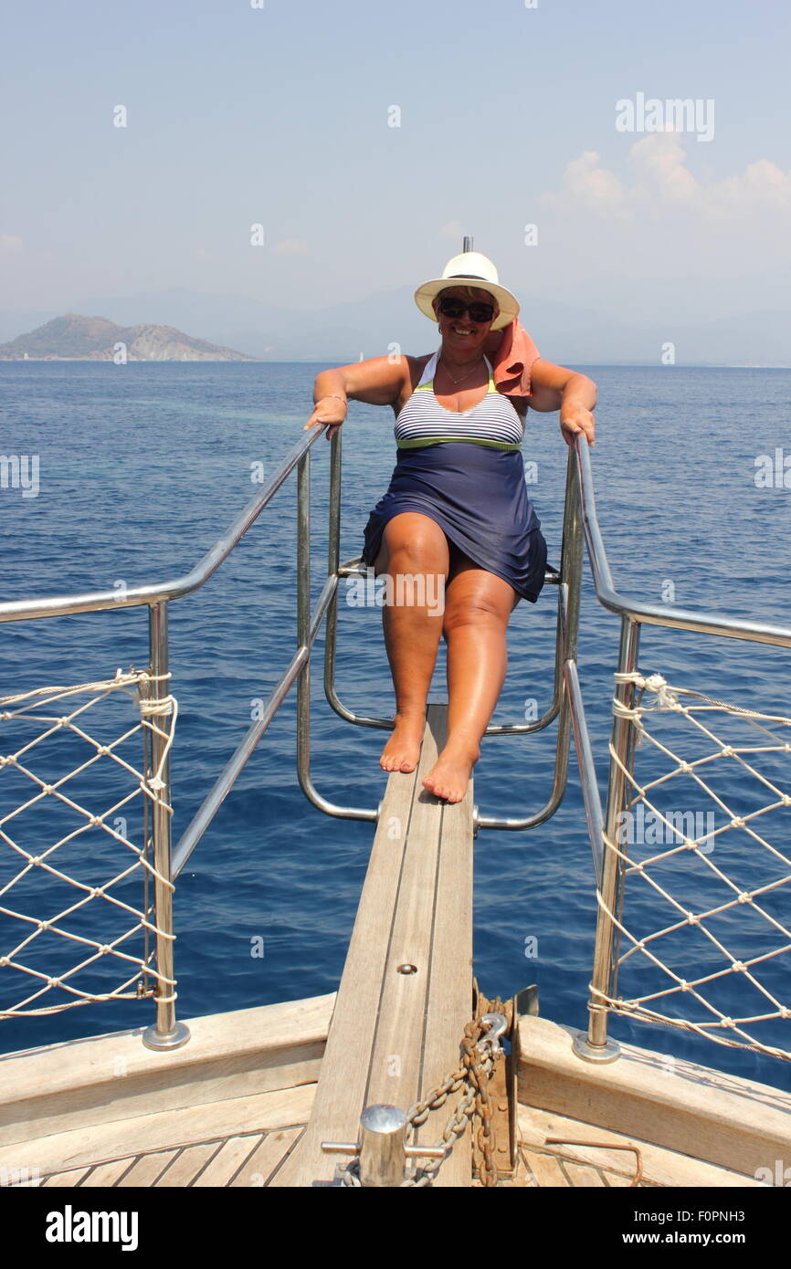 An english lady relaxing while on a boat trip around the bays at ...