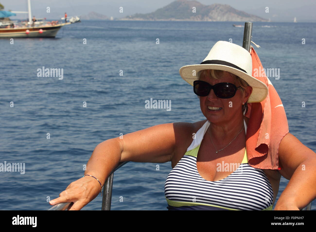 An english lady relaxing while on a boat trip around the bays at ...