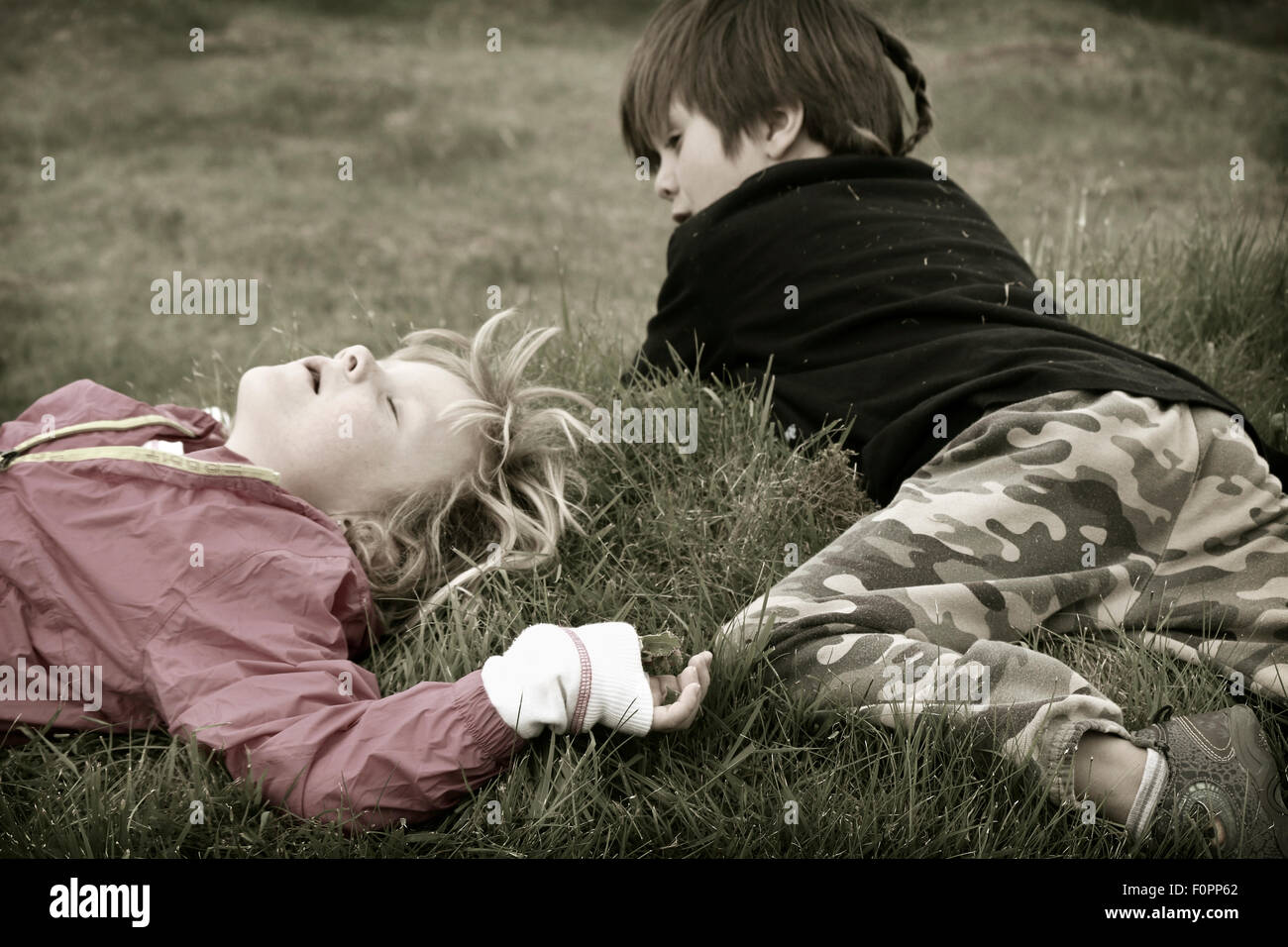 Children playing in a grassy field Stock Photo - Alamy