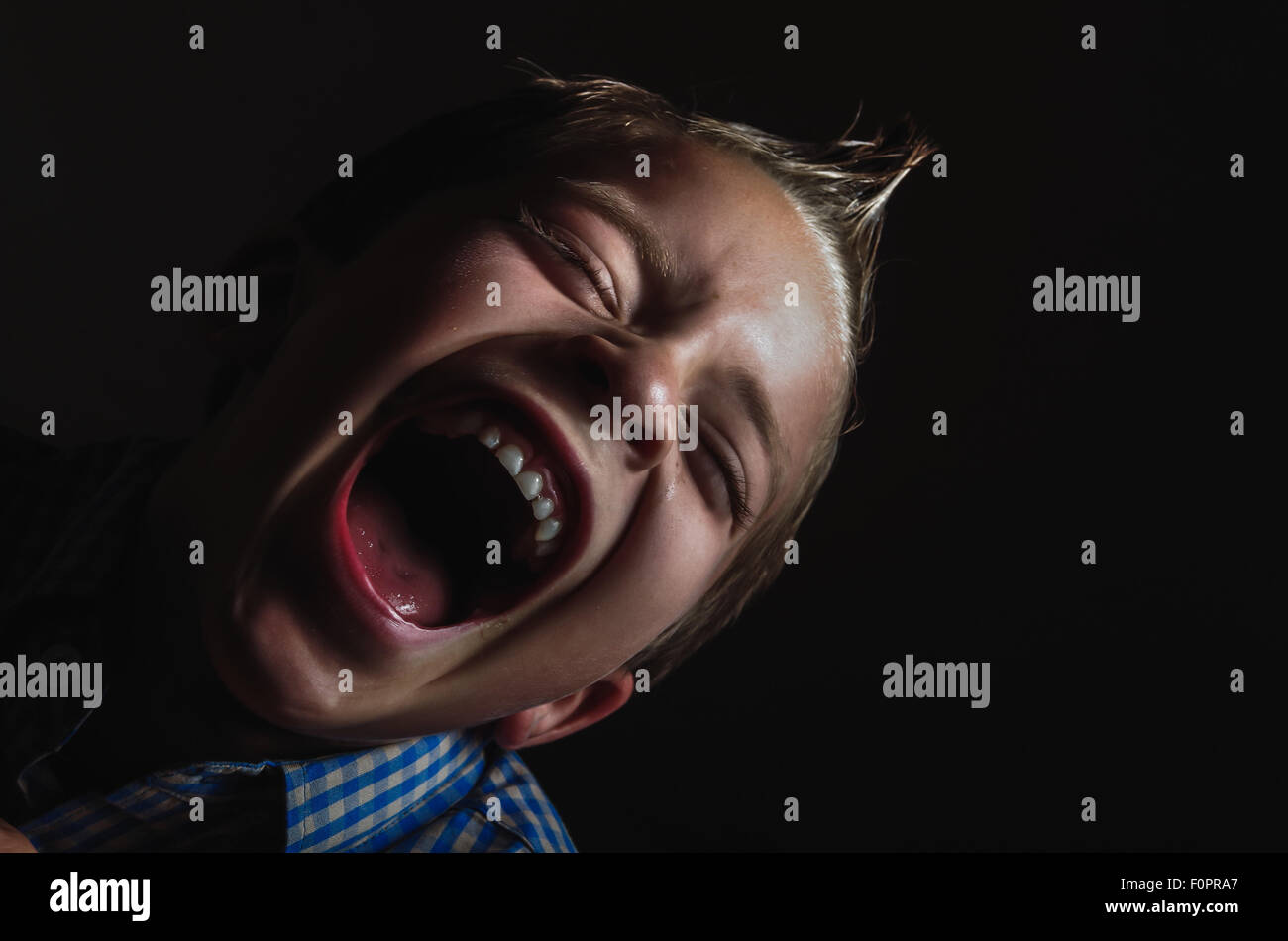 Cute little boy screaming Stock Photo - Alamy