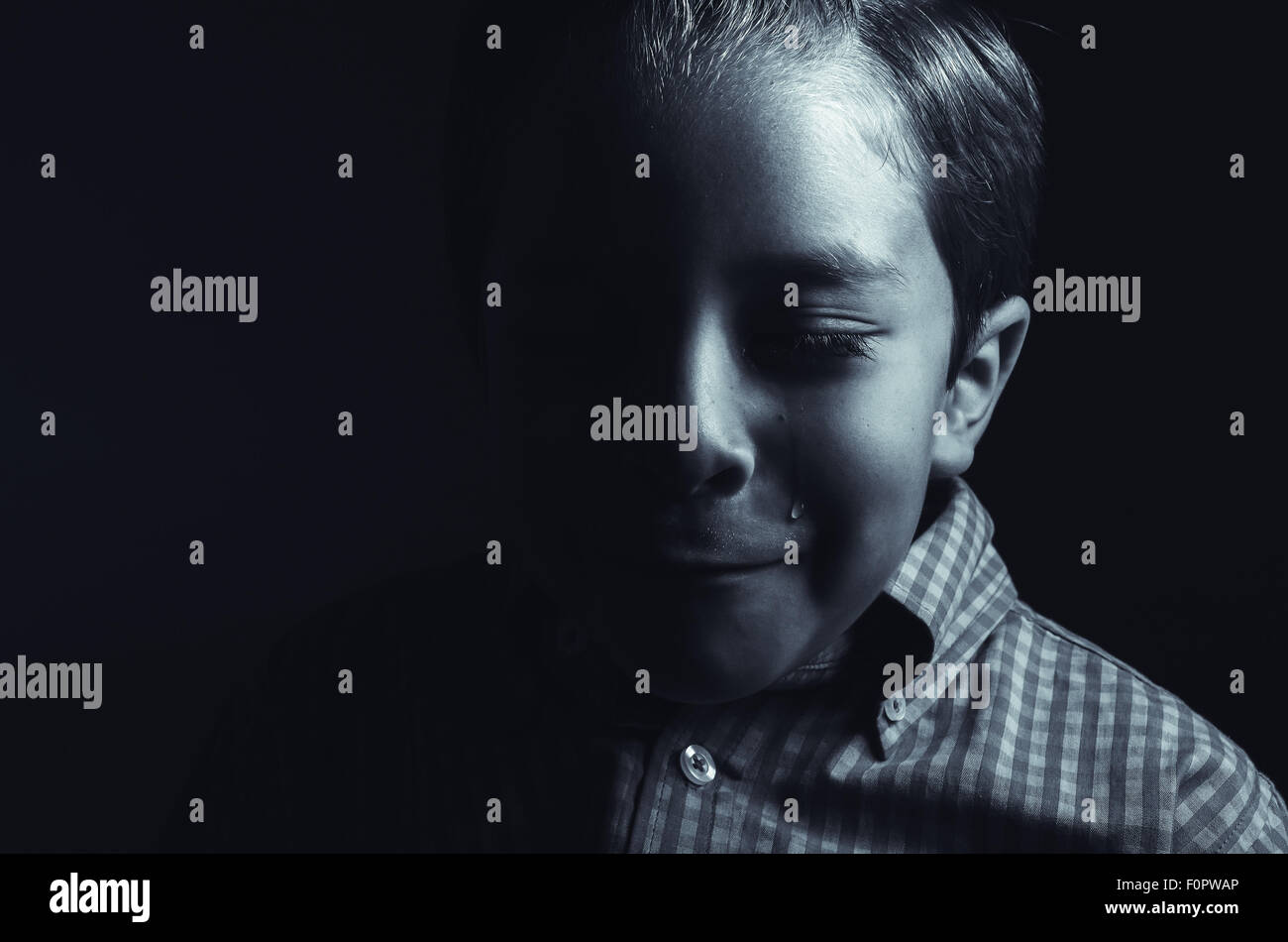 Black and white low key portrait of sad little boy crying Stock Photo ...