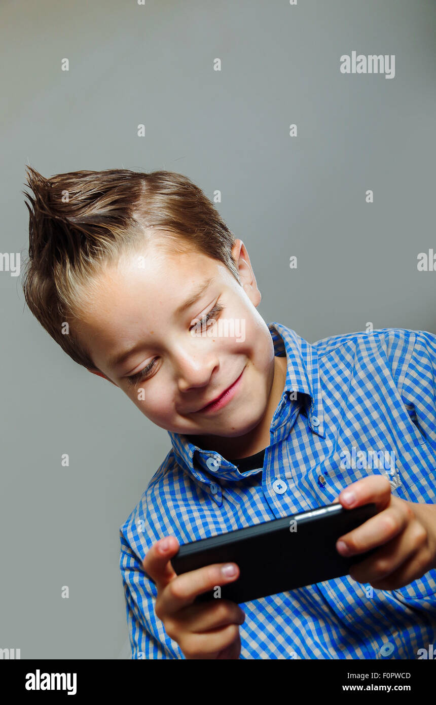 Cute boy using cell phone Stock Photo - Alamy