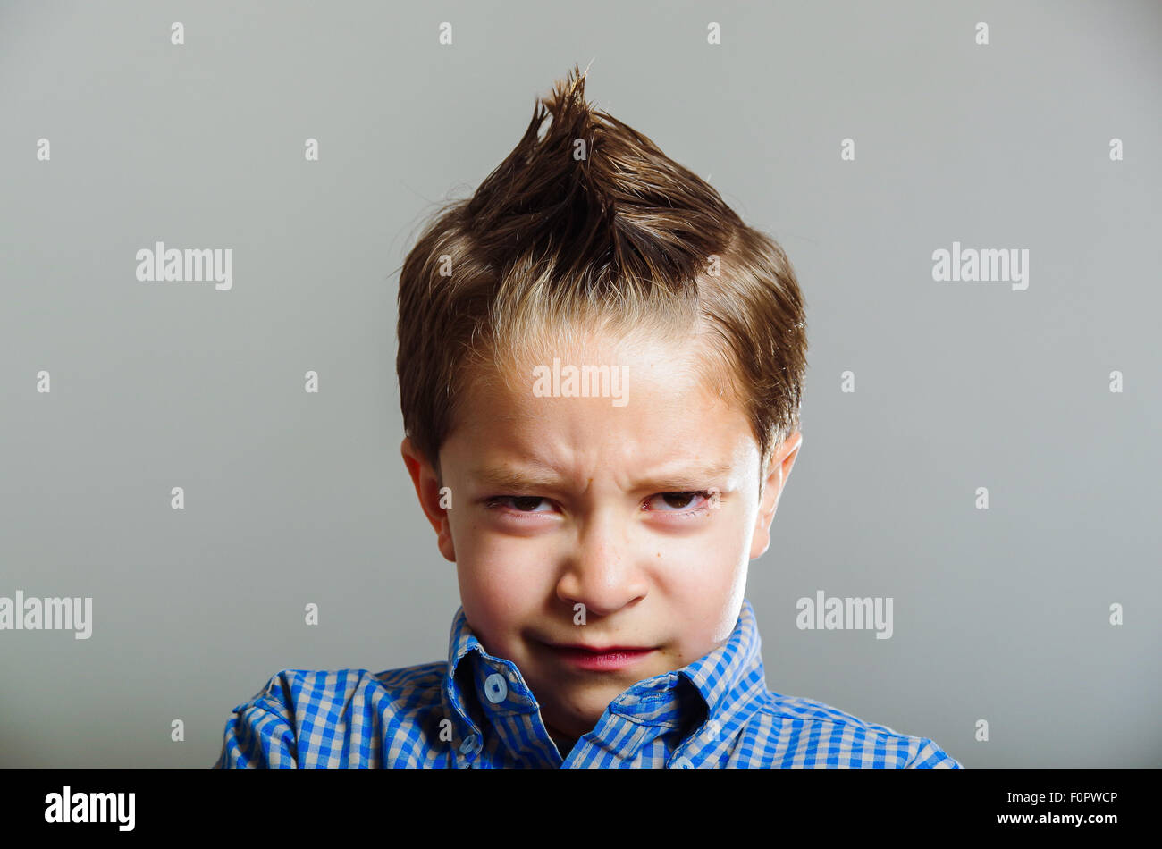 Sweet little boy gesturing anger Stock Photo - Alamy