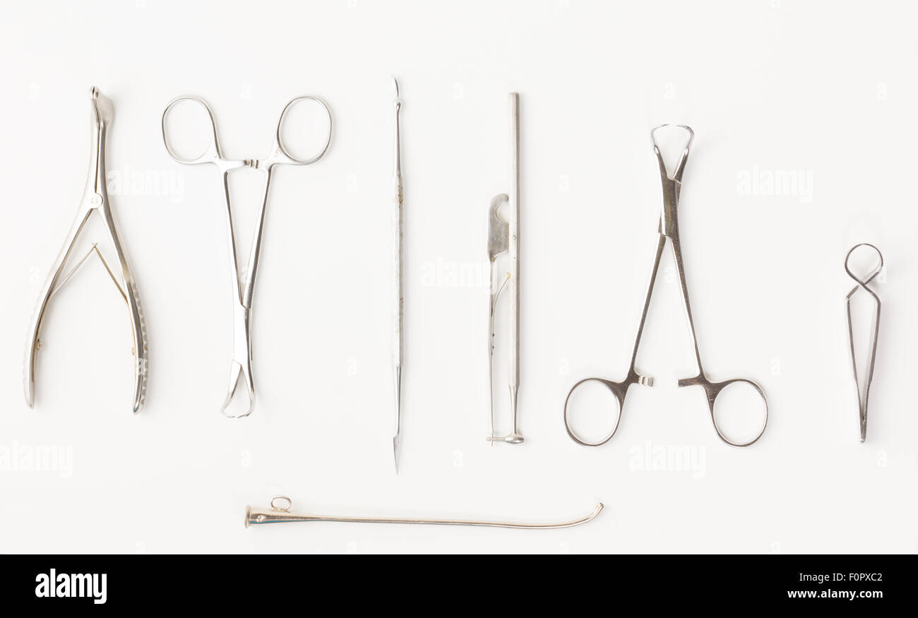 some chrome medical surgical tools lie on a white background Stock ...