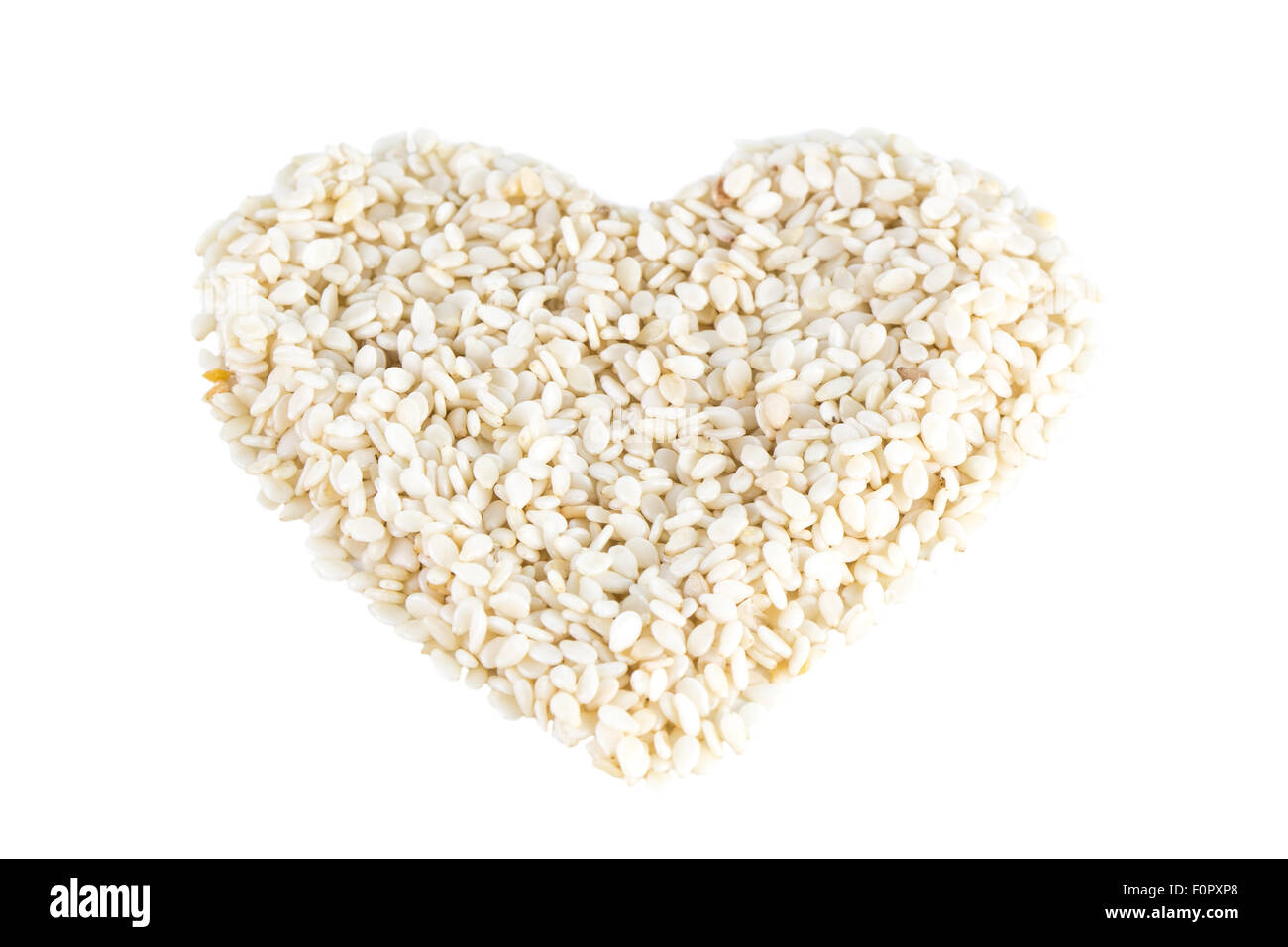 Heart shape made of sesame seeds with no shell, tilted angle, isolated ...