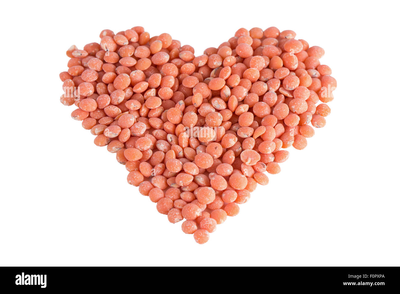 Heart shape made of red lentils, tilted angle, isolated on white ...