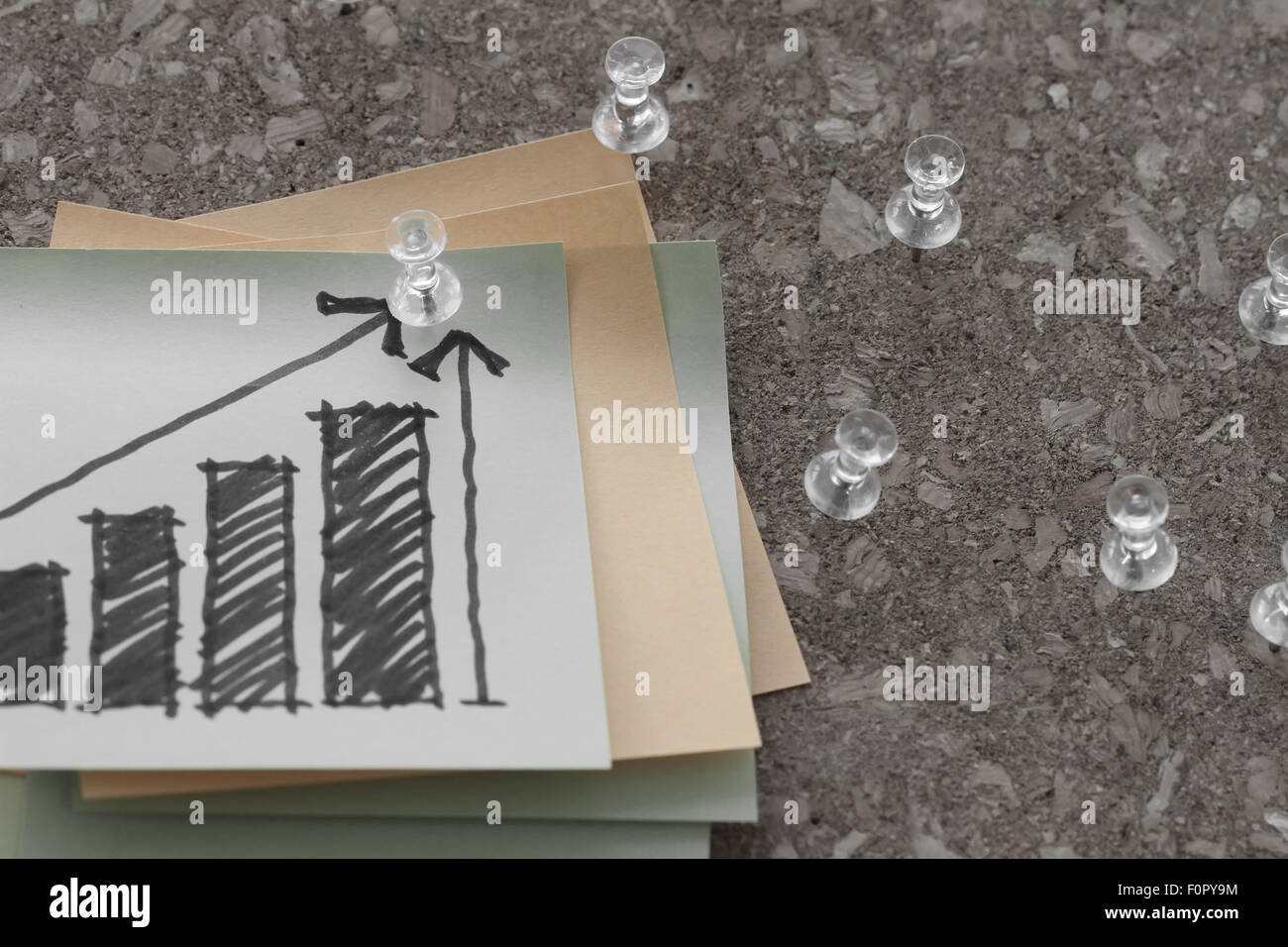 close up of pin and hand drawn business strategy graph chart on sticky ...
