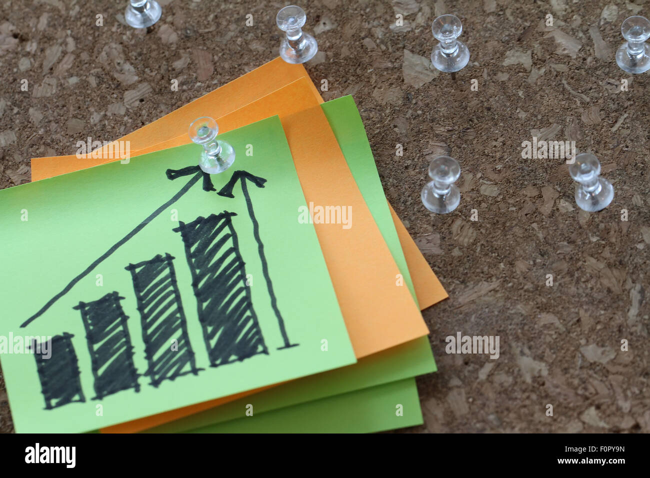 close up of pin and hand drawn business strategy graph chart on sticky ...