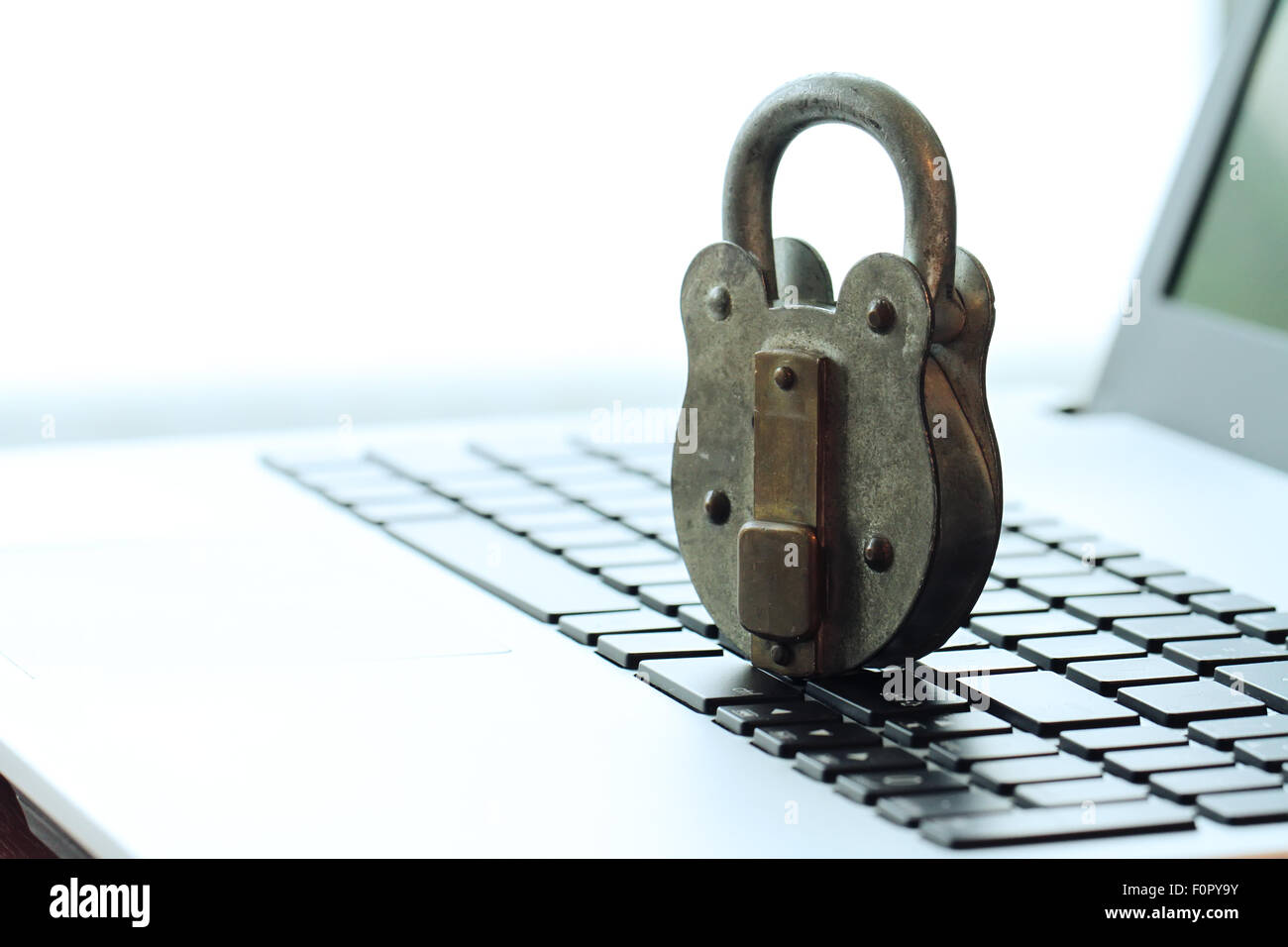 Internet security concept-old padlock and key on laptop computer ...