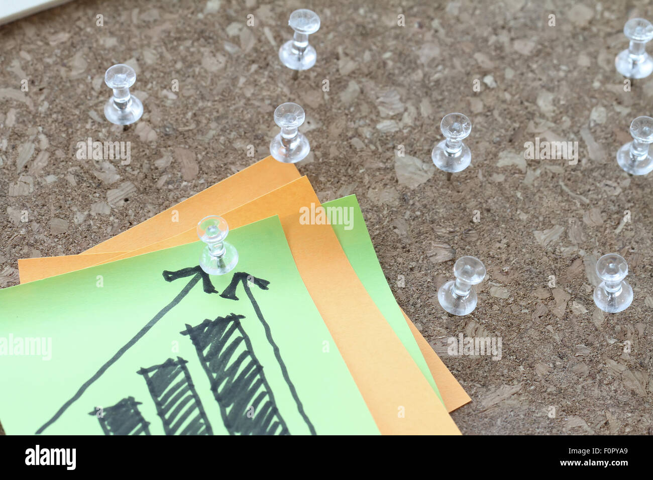 close up of pin and hand drawn business strategy graph chart on sticky ...