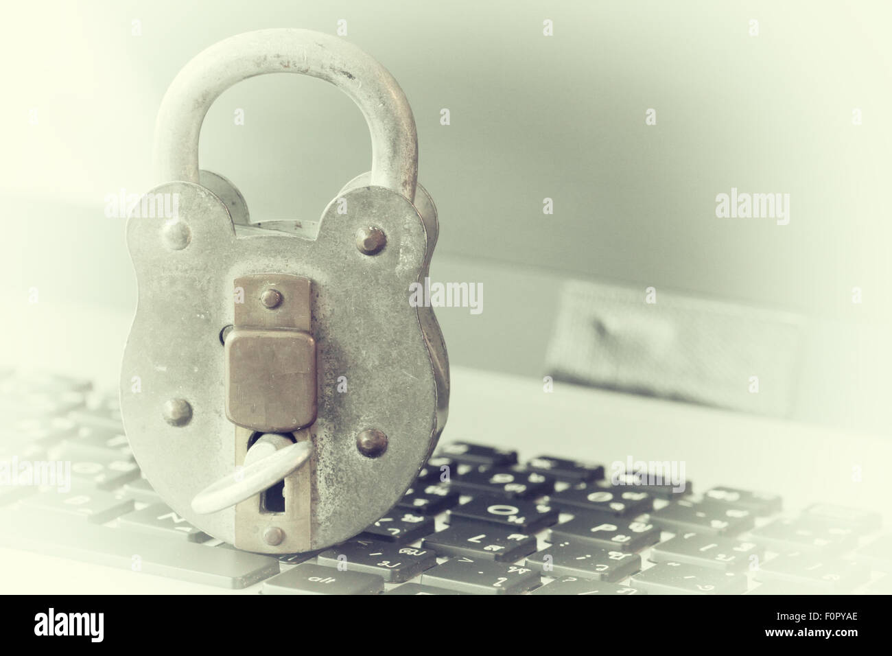 Internet security concept-old padlock and key on laptop computer ...