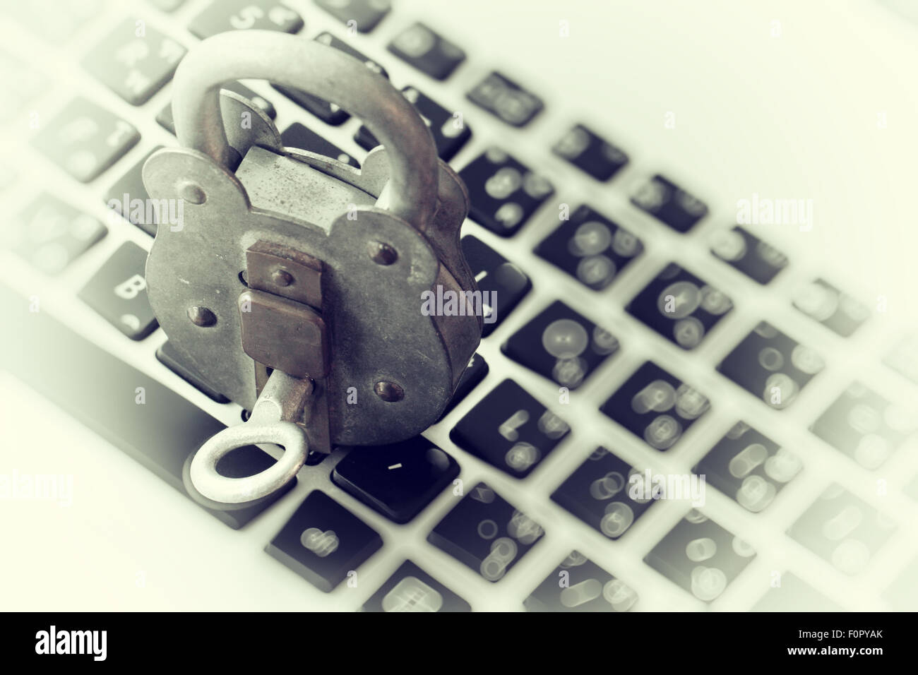 Internet security concept-old padlock and key on laptop computer ...