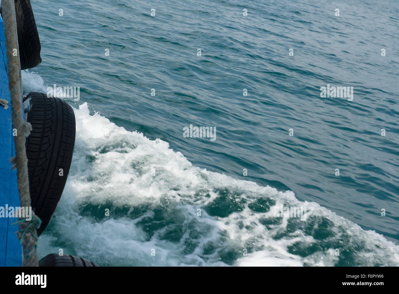 sea waves in a vessel board forming white foam Stock Photo - Alamy