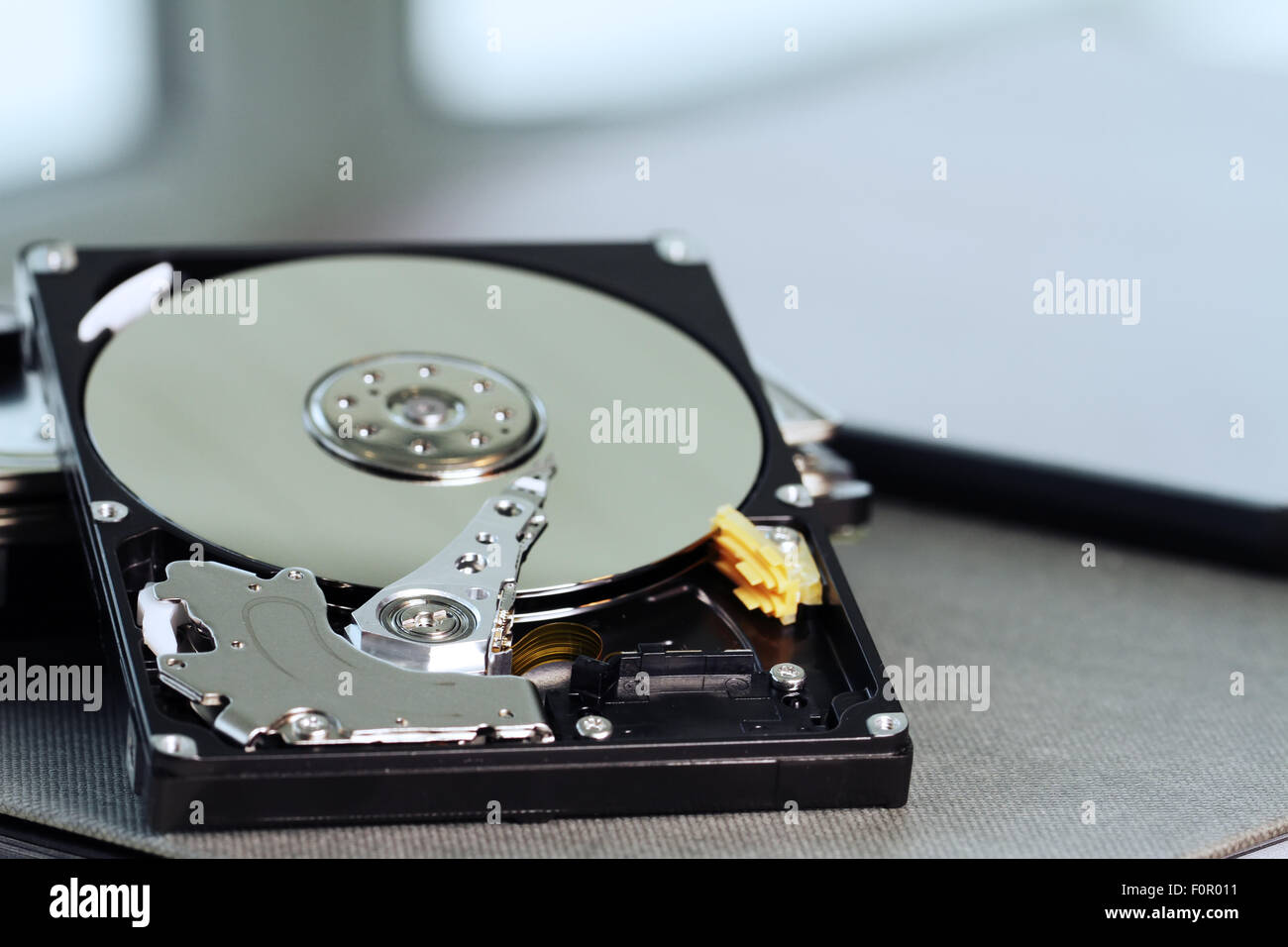 Close up of open computer hard disk drive on desk and notebook Stock ...
