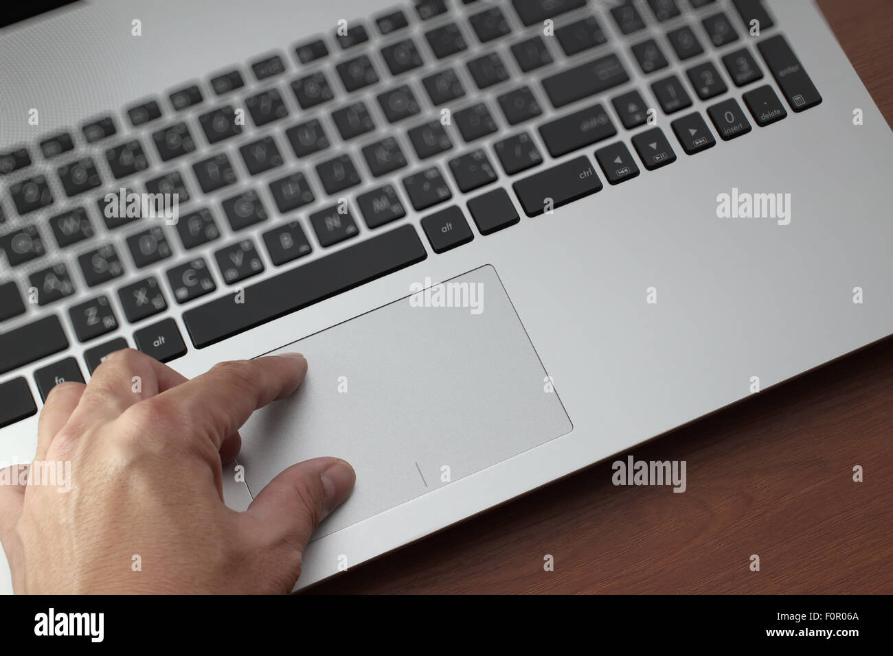 Close up of business man hand working on blank screen laptop computer ...
